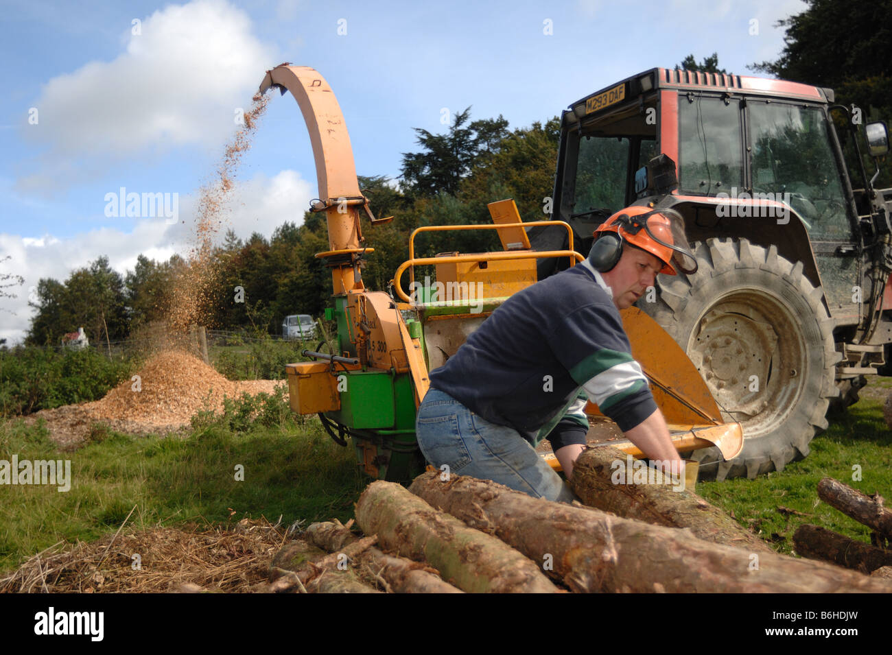 Using a mobile Woodchip machine to chop up logs for use in a biomass ...