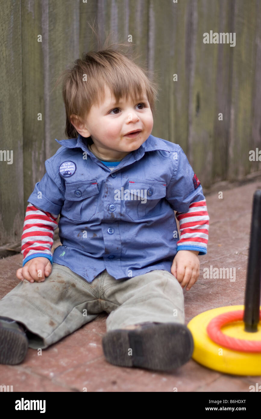 Child sitting outside Stock Photo - Alamy