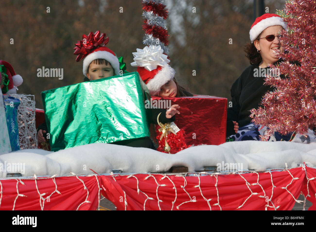 Family riding on a Christmas parade float Stock Photo - Alamy