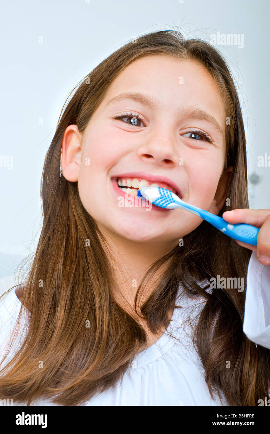 young girl brushing her teeth happily Stock Photo - Alamy