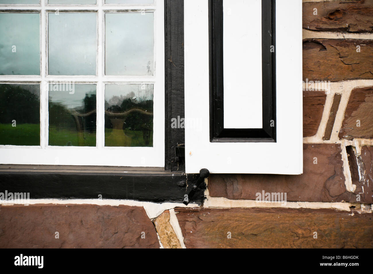 Detail of an Early American stone house's window with hand blown glass ...