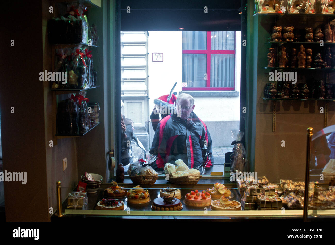 People looking at the window display in a Bruges Bakery (shot from ...