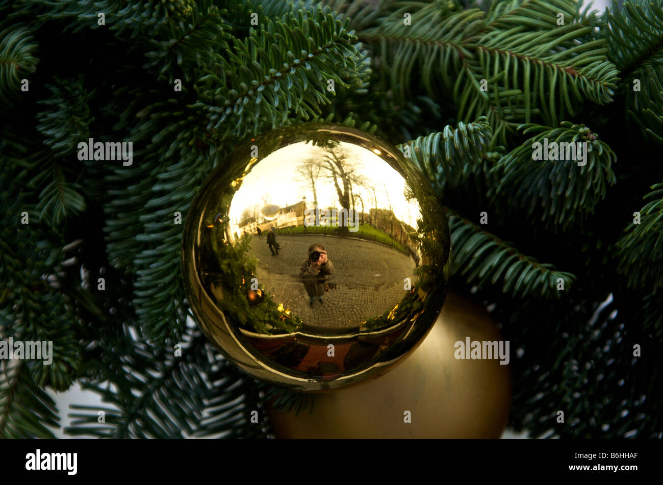 Reflection of two people in a christmas ornament in Bruges, Belgium ...