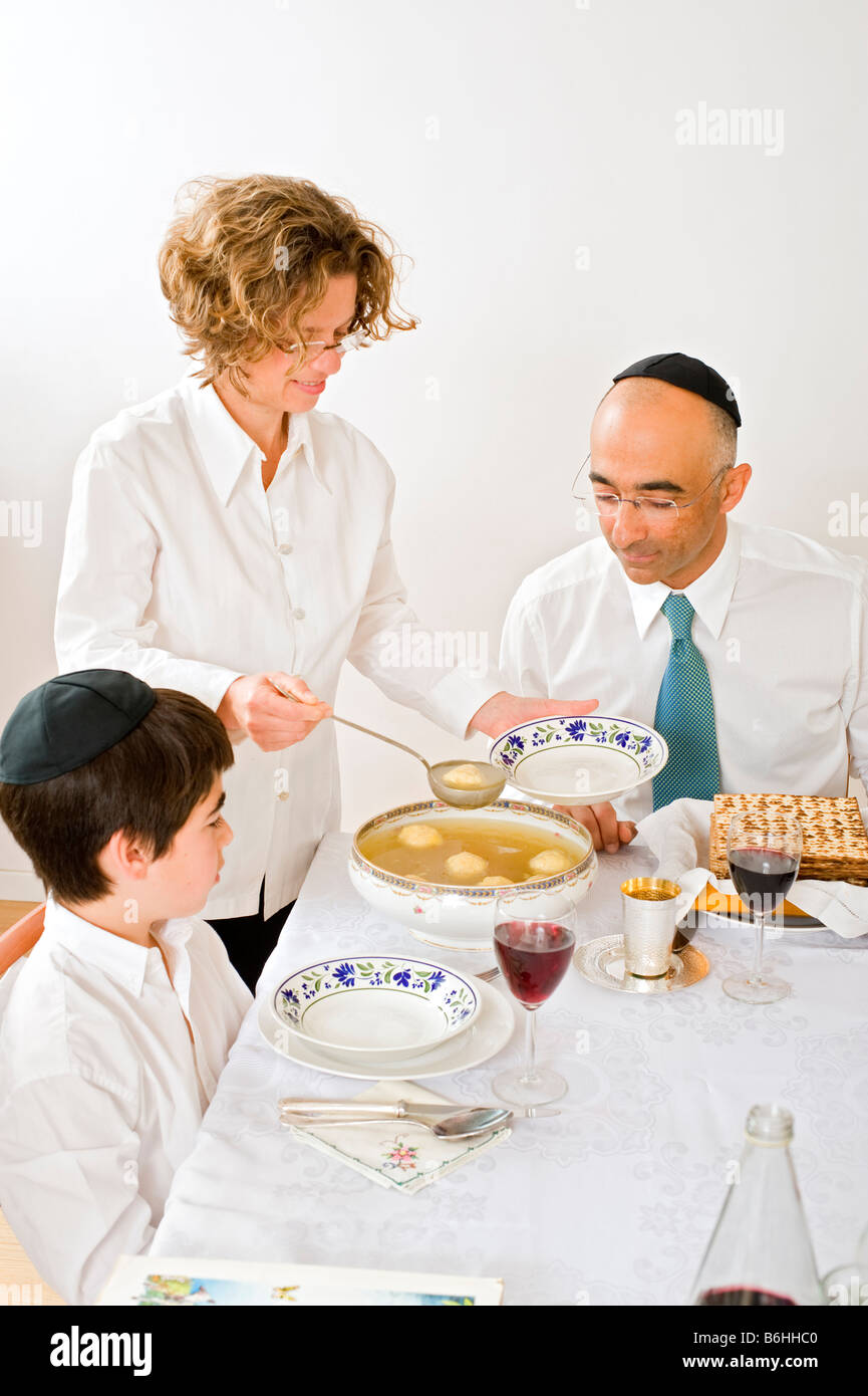 mother serving Kneidel soup at Passover family Seder Stock Photo - Alamy