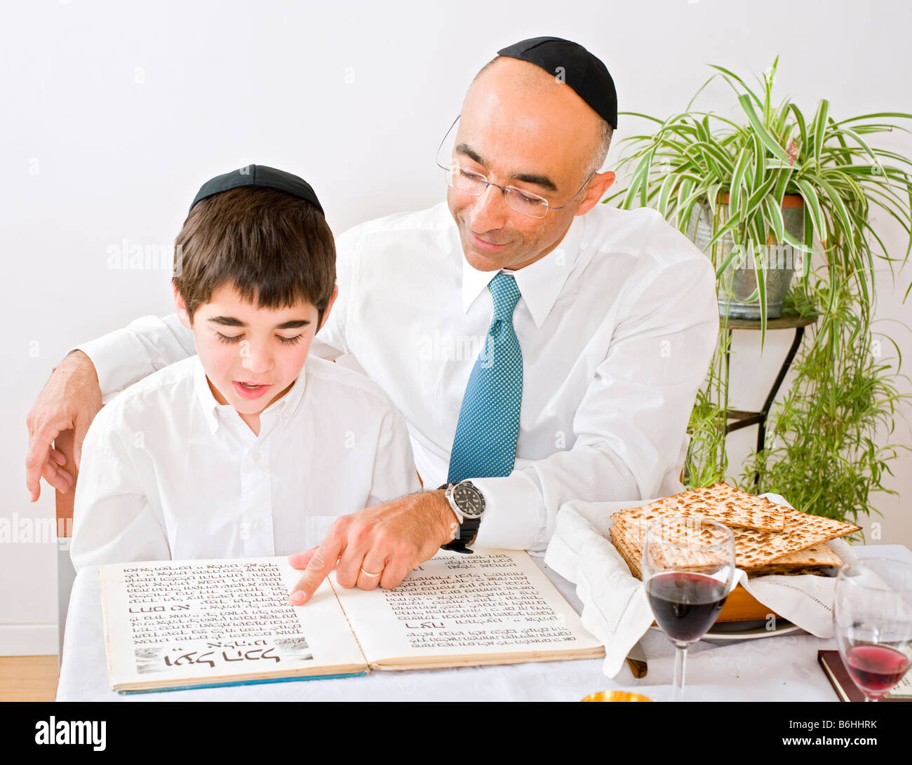 father and son celebrating passover reading the Hagada Stock Photo - Alamy