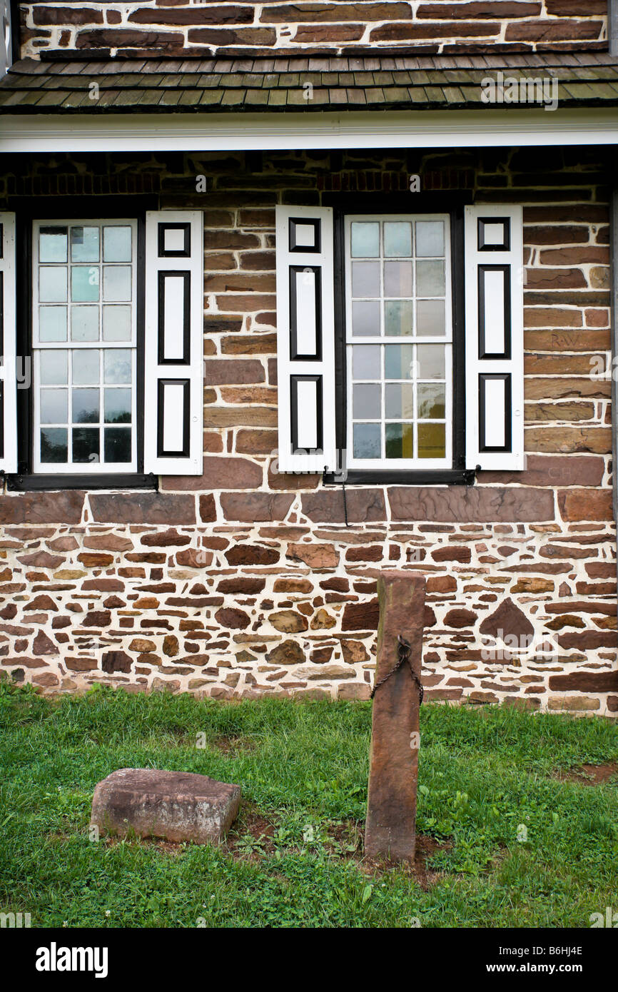 A stone hitching post and mounting block in front of a colonial ...