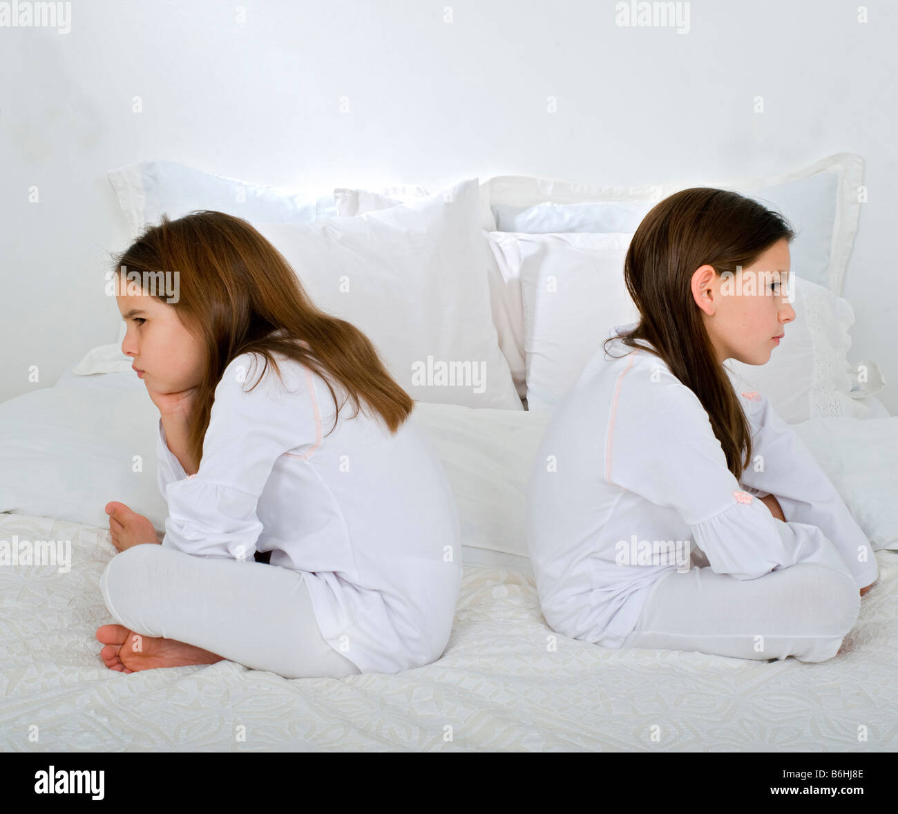 two little girls back to back in quarrel Stock Photo - Alamy