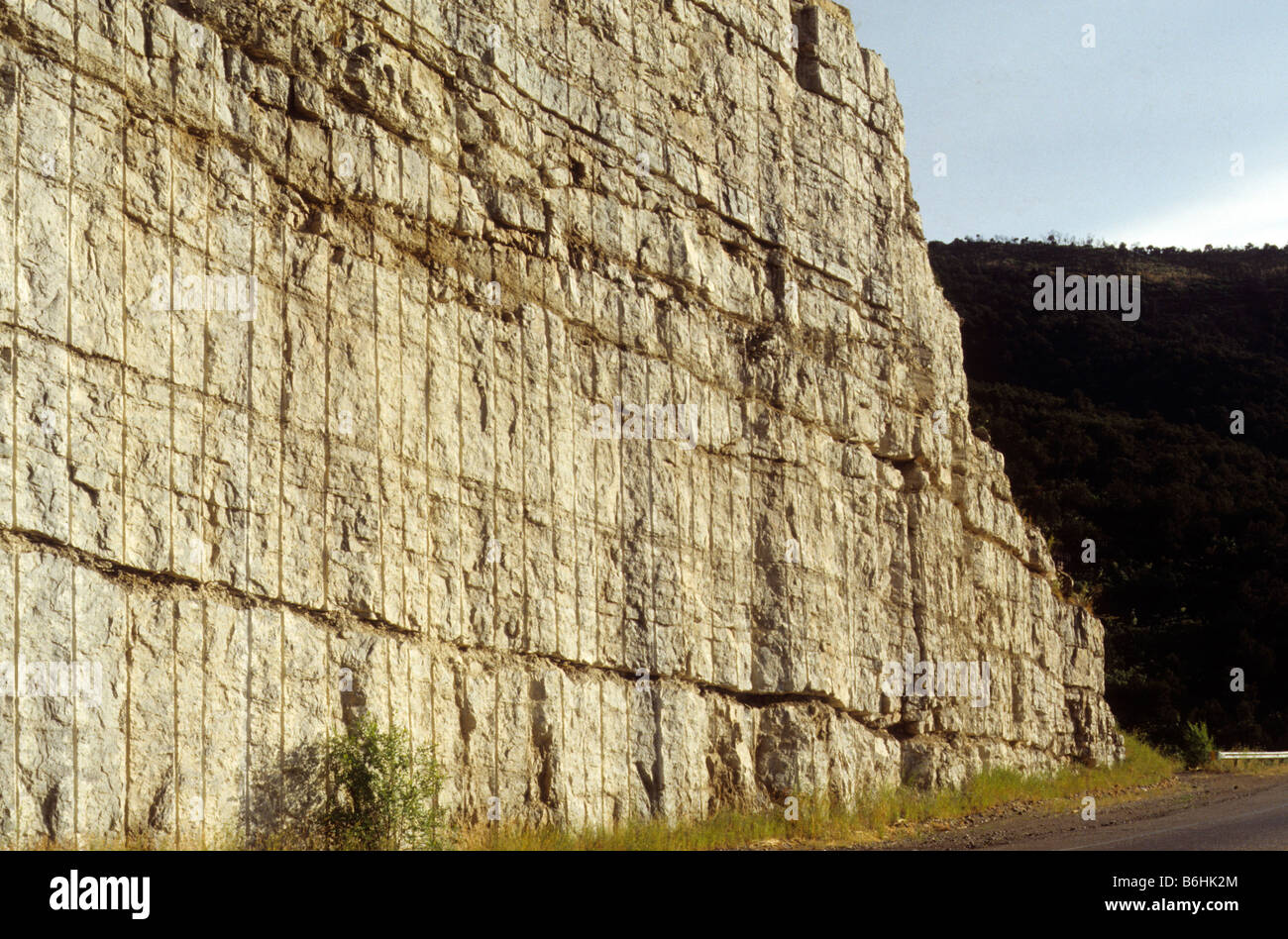 Rock strata is exposed by cut made for highway Stock Photo - Alamy