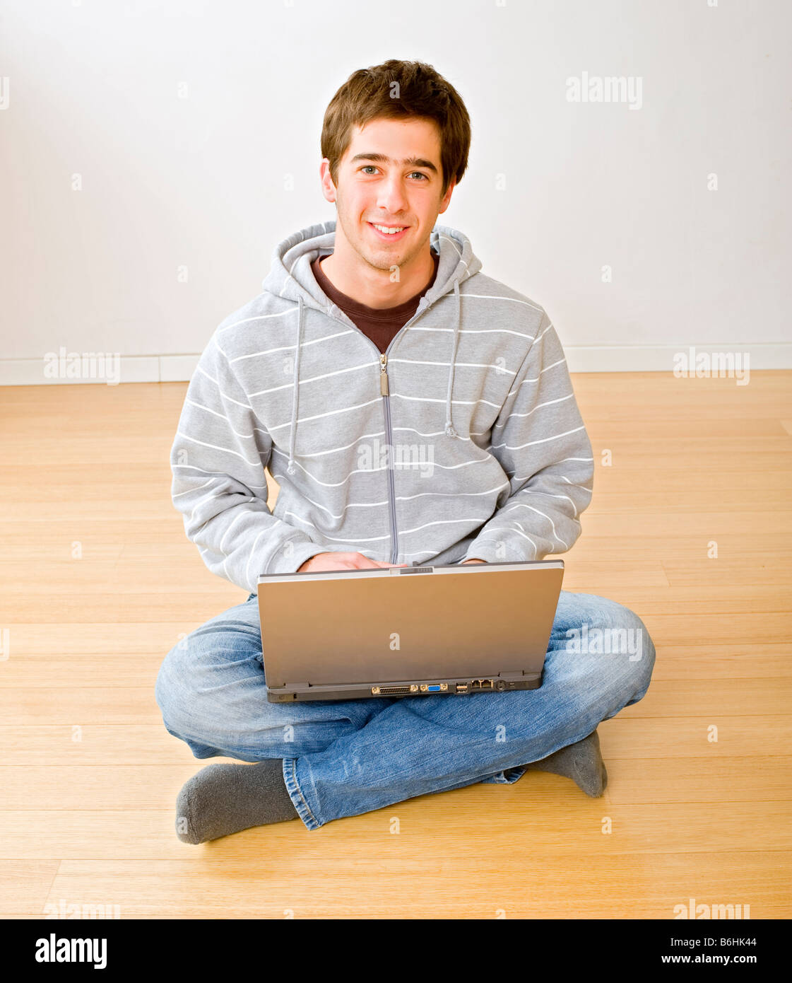 teenager and laptop computer on a parquet floor Stock Photo - Alamy