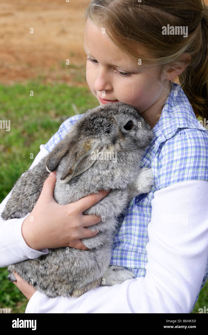 Young girl holding a rabbit Stock Photo - Alamy