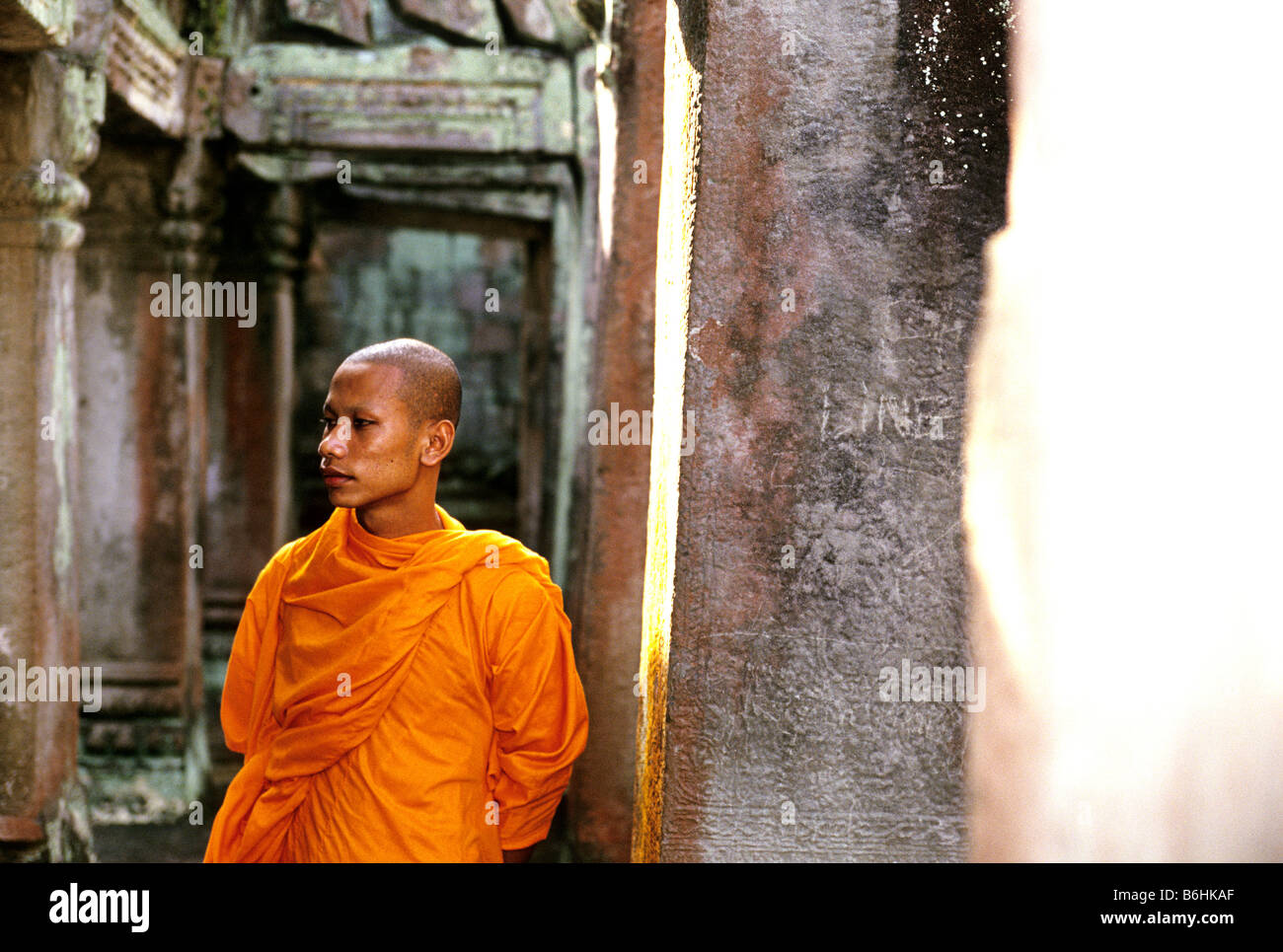 Novice monk in saffron robes at the unrstored 12th century temple of ...