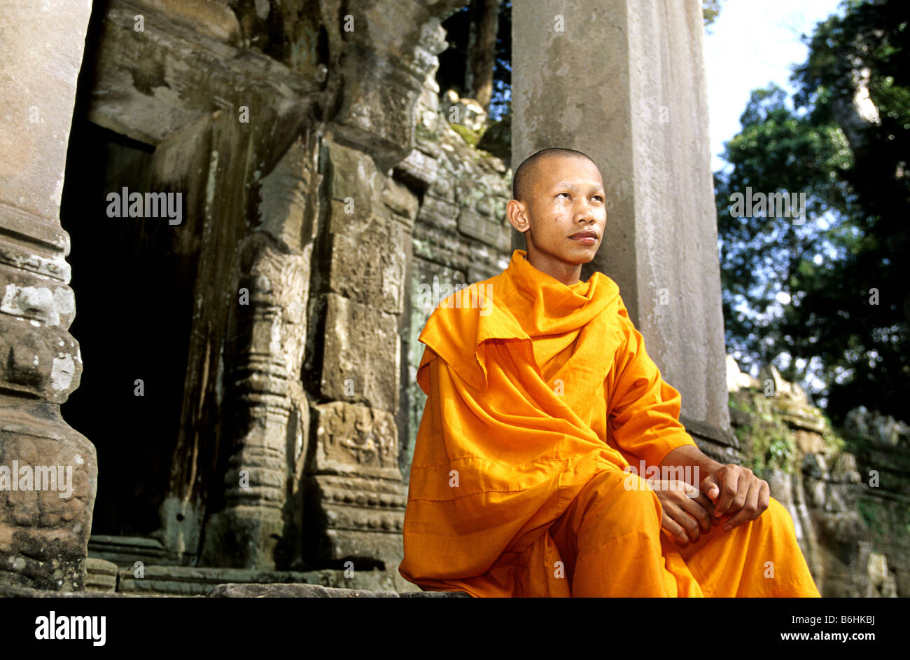 Novice monk in saffron robes at the unrstored 12th century temple of ...