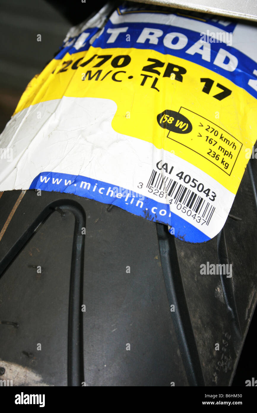 New front tyre fitted to motorcycle, with the label still attached ...