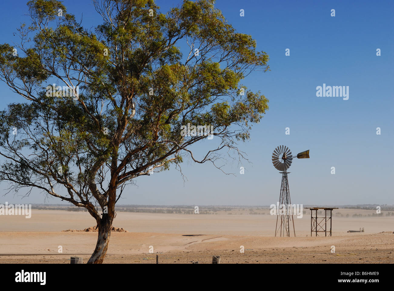 Abandoned windmill in a barren farm paddock in outback Australia. The ...