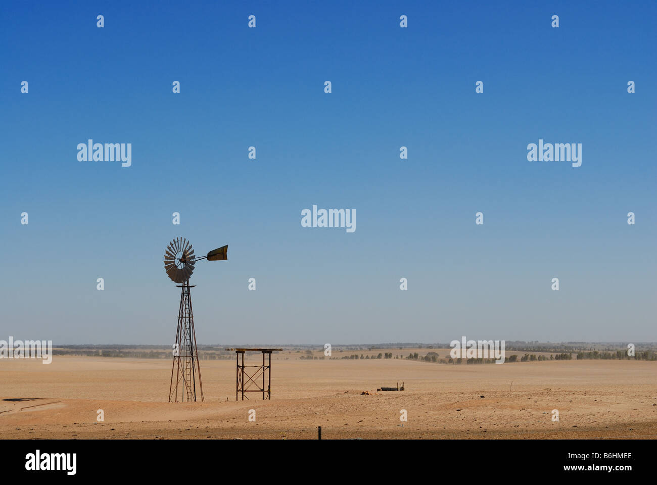 Abandoned windmill in a barren farm paddock in outback Australia. The ...