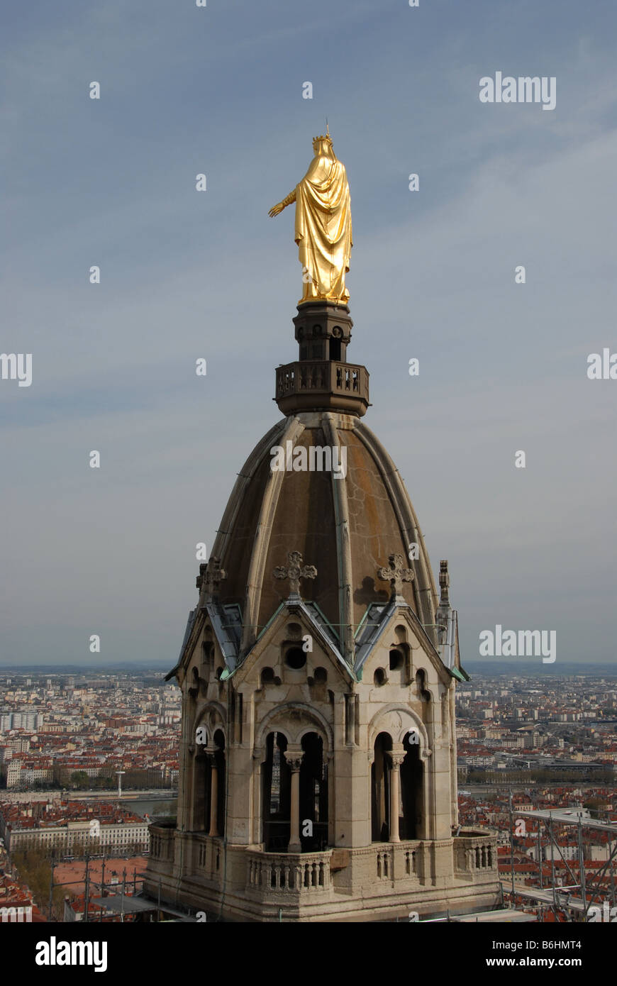 A gold statue of the Golden Virgin on one of the octagonal towers of ...