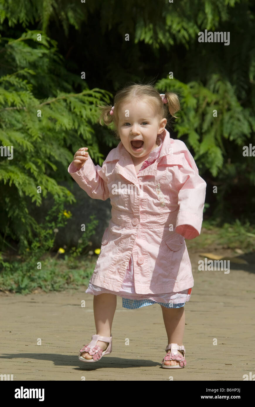 cute one year old girl taking her first steps Stock Photo - Alamy
