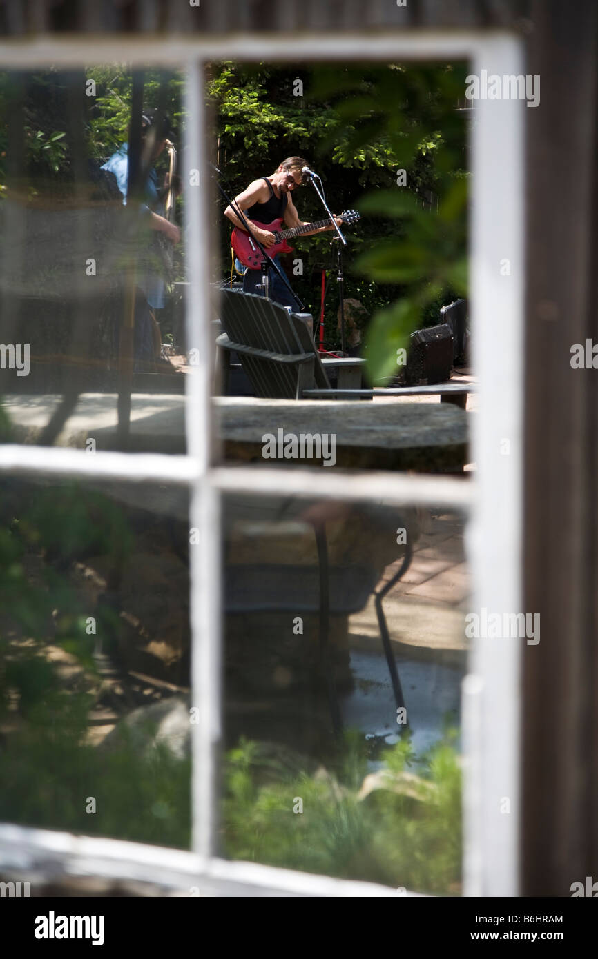 Band playing in garden, show through a window, Volcano California, USA ...