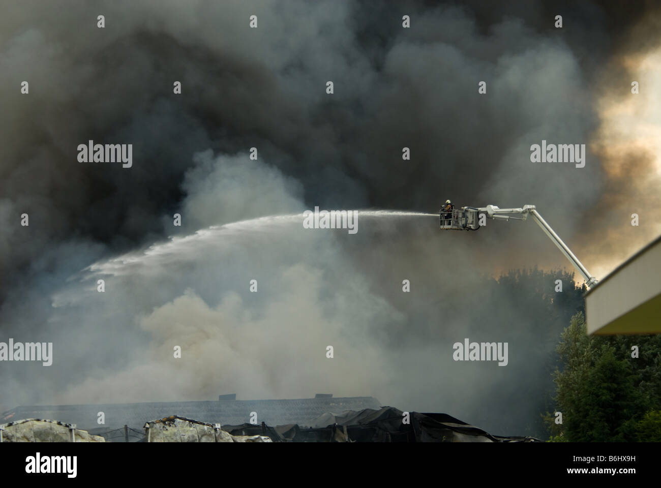 a huge fire with firefighters in action Stock Photo - Alamy