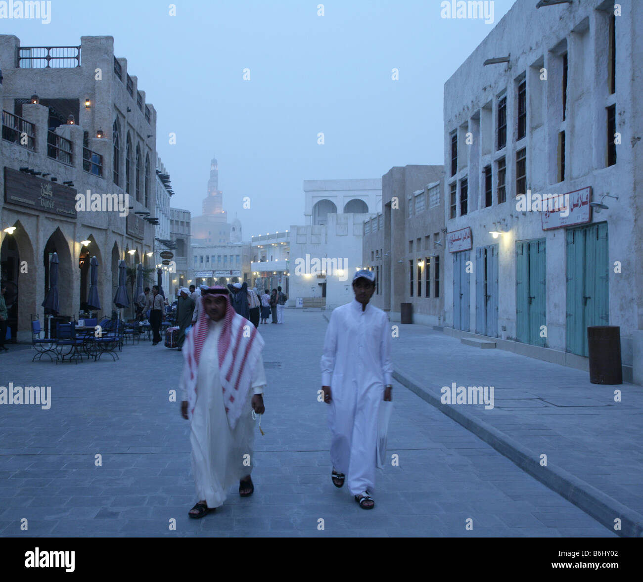 Locals strolling through the Souq Waqif market in Doha, Qatar Stock ...