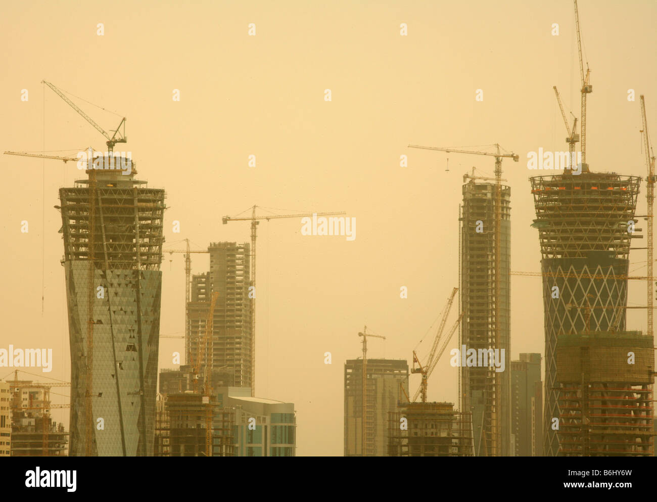 Construction site with construction cranes on top circular skyscrapers ...