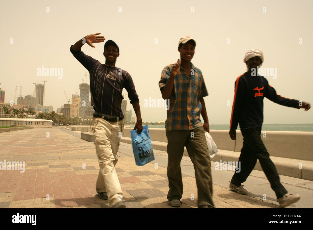 Men walking along the Corniche of Doha, Qatar Stock Photo - Alamy