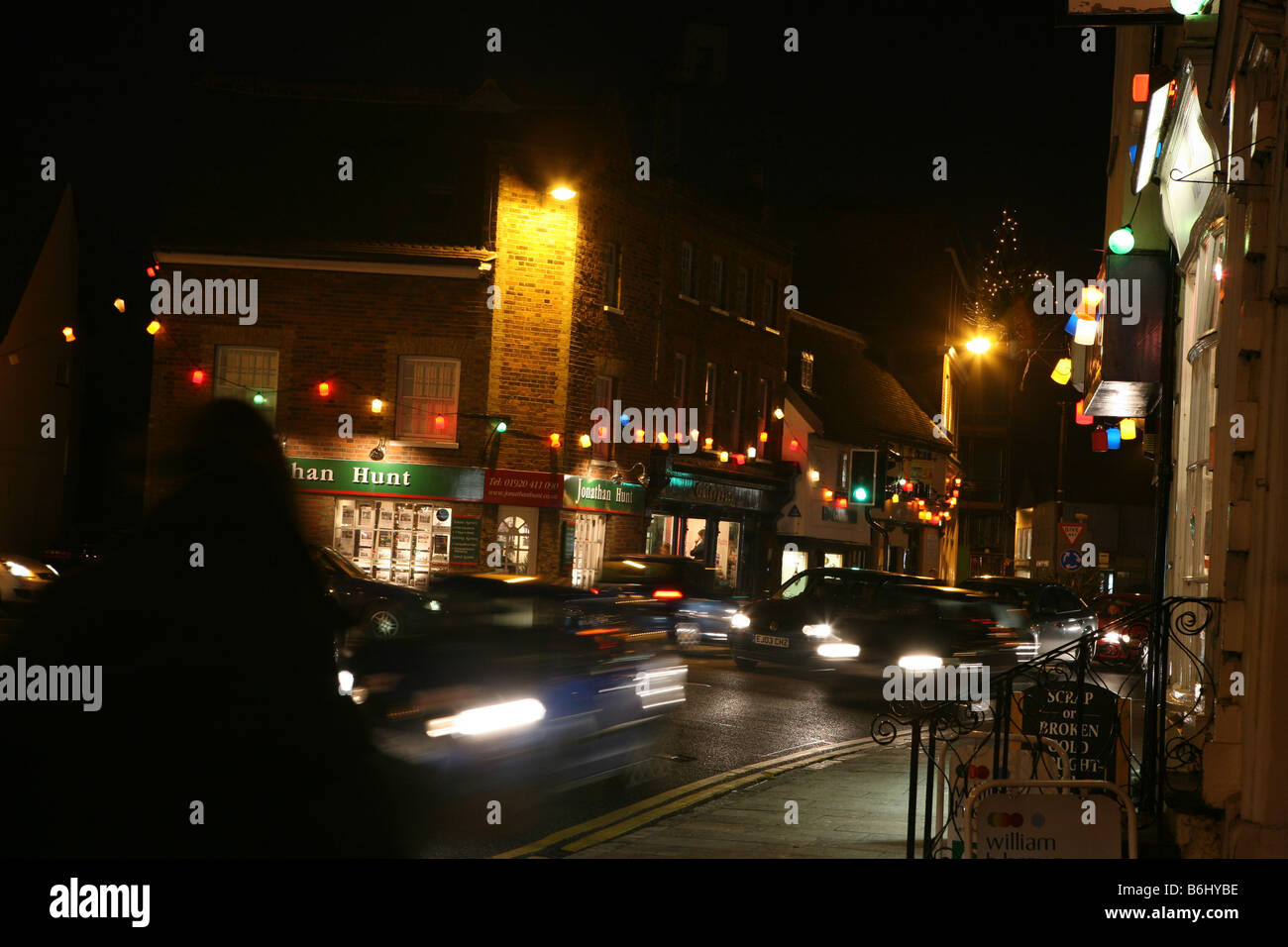 a street scene of a quintessential english town at night during ...