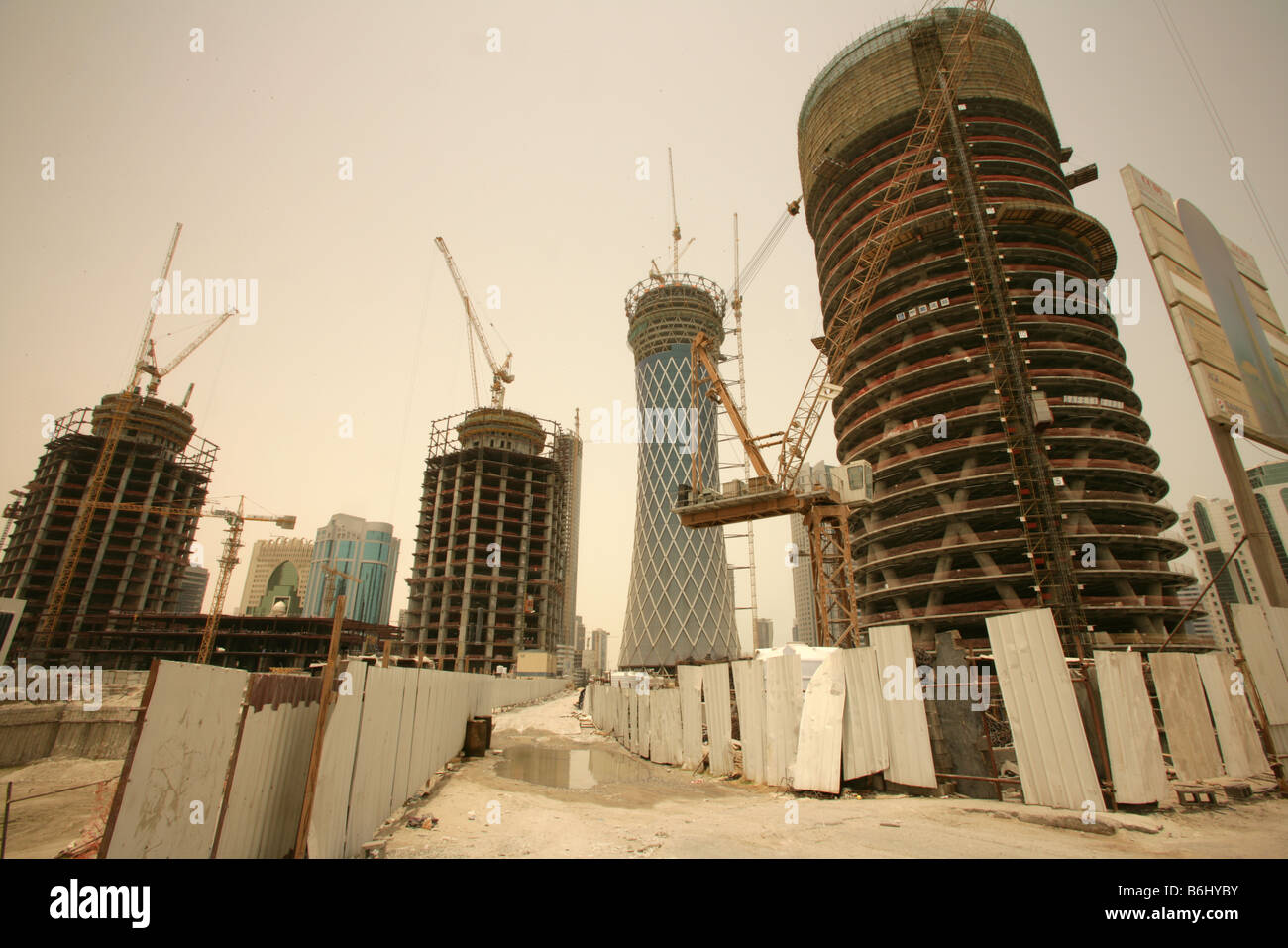 Construction site with construction cranes on top circular skyscrapers ...