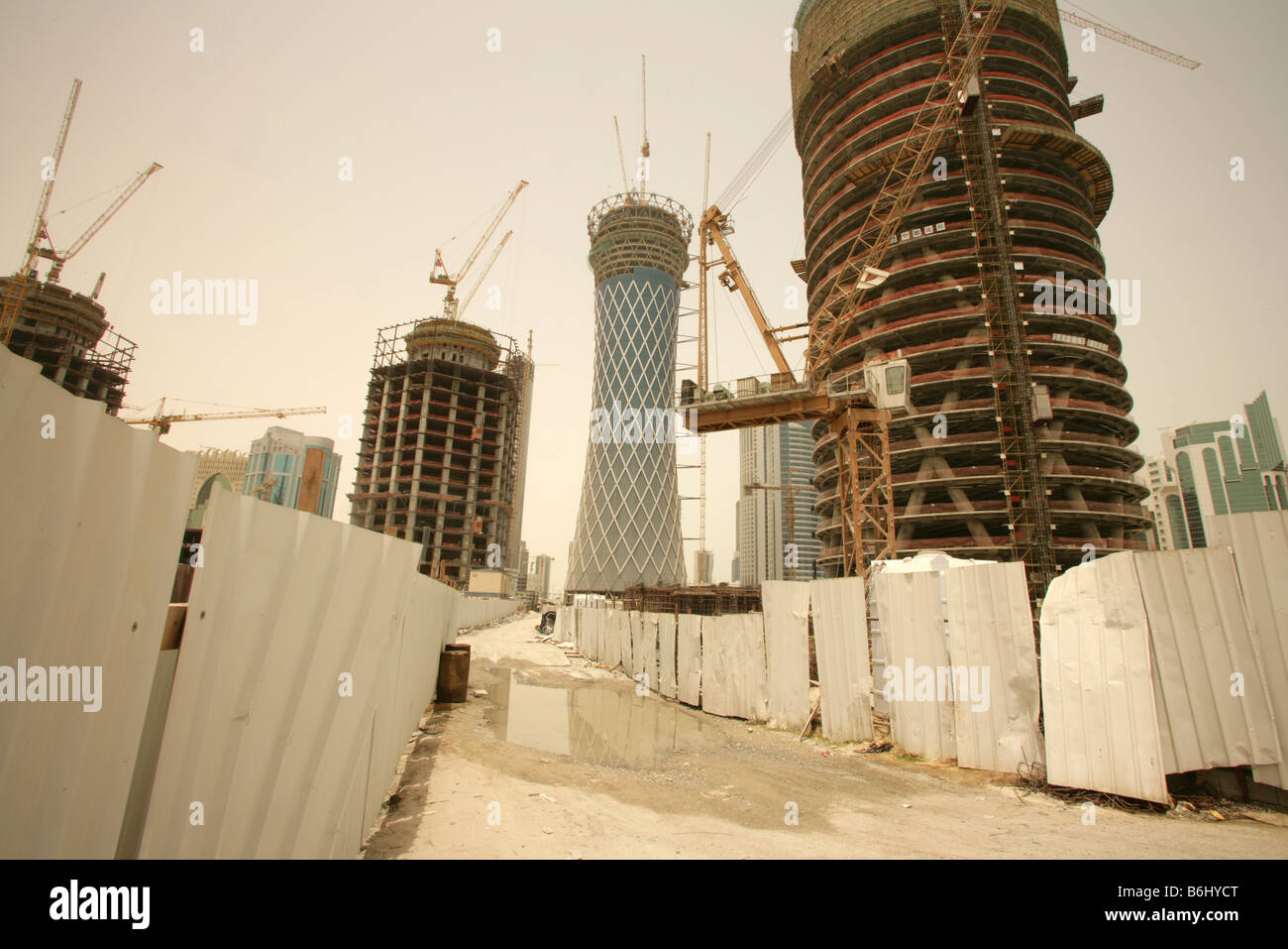 Construction site with construction cranes on top circular skyscrapers ...