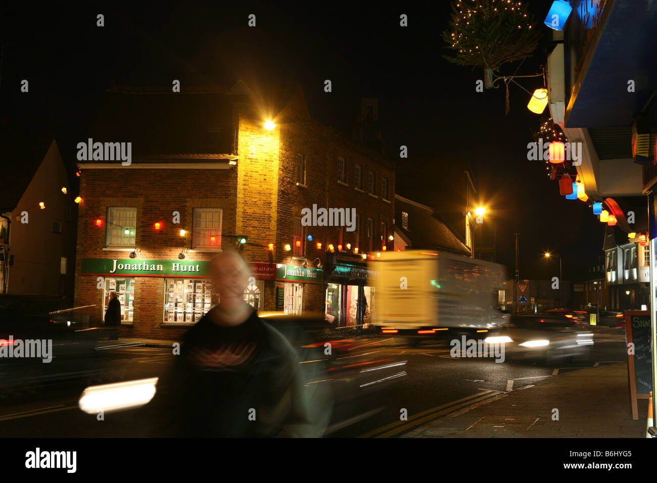 a street scene of a quintessential english town at night during ...