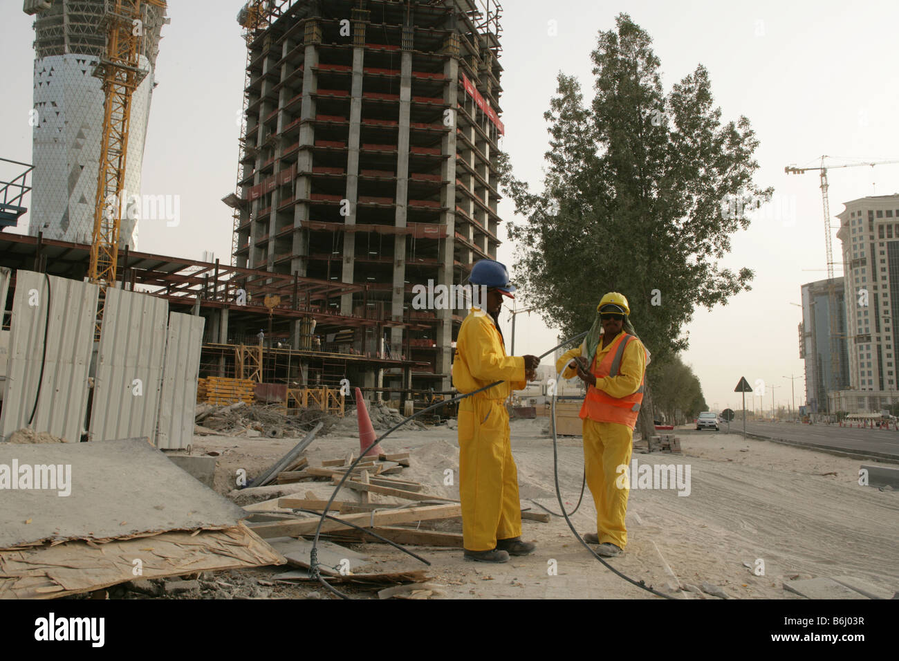 Two construction workers on skyscraper construction site, Doha, Qatar ...