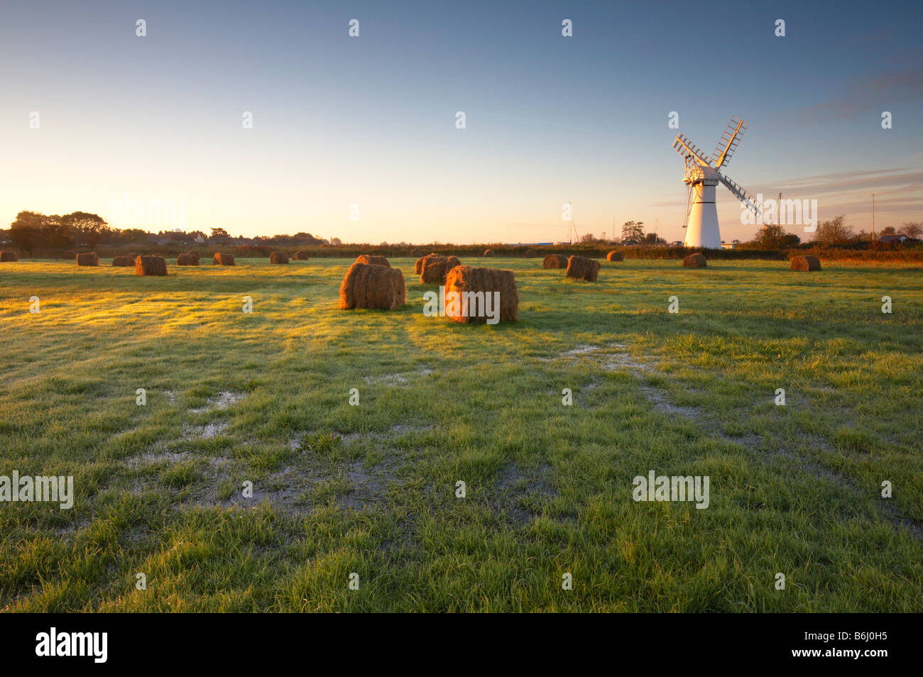 Thurne windmill and hay bales on marshland on the Norfolk Broads Stock ...