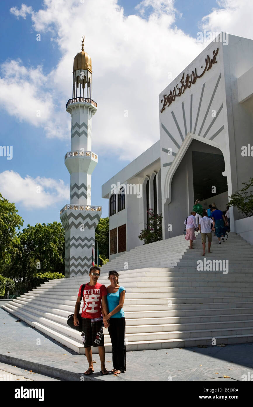 Tourists posing for a photograph outside The Grand Friday Mosque and ...