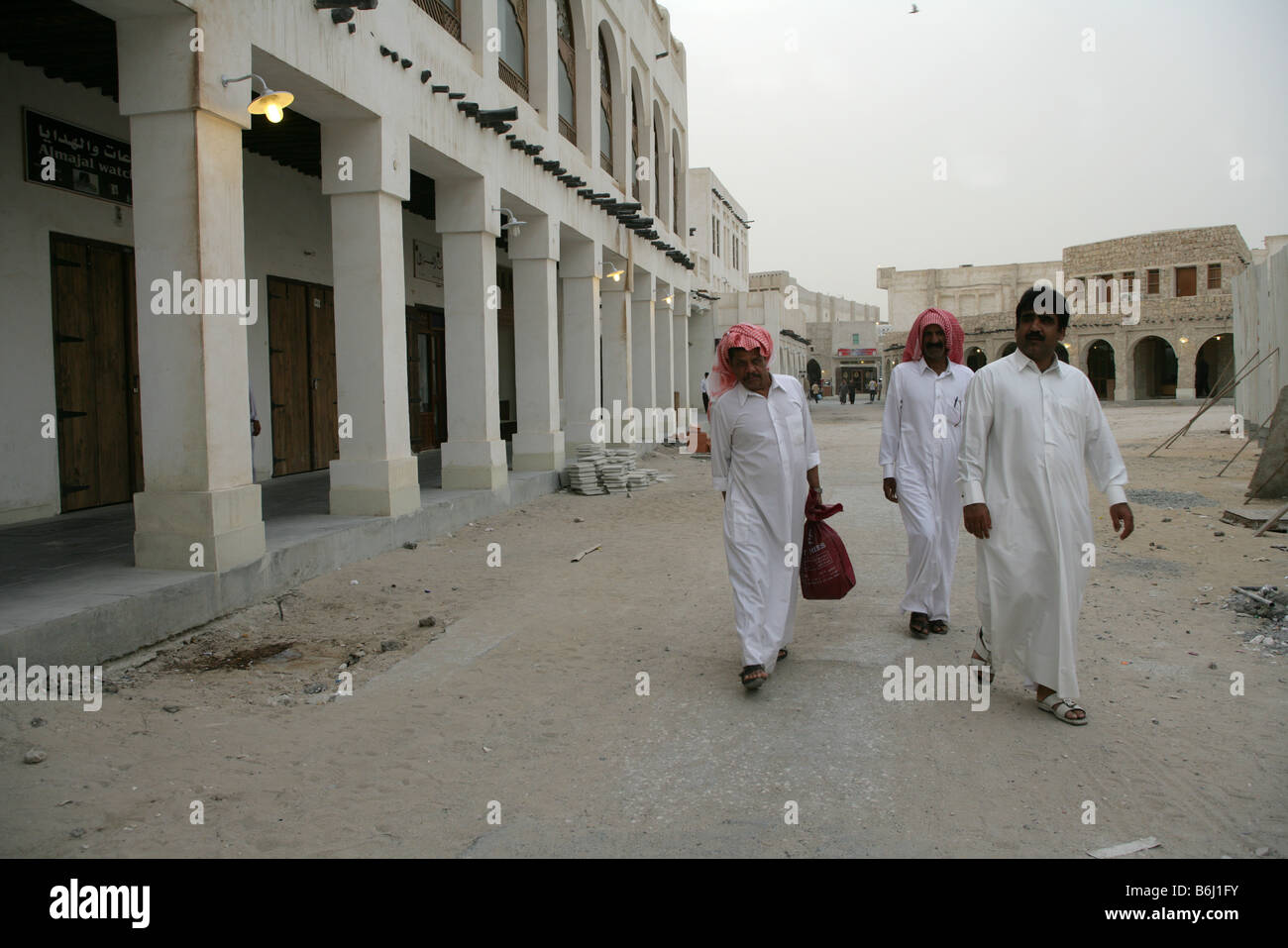 Men in traditional attire on the street of Doha, Qatar Stock Photo - Alamy