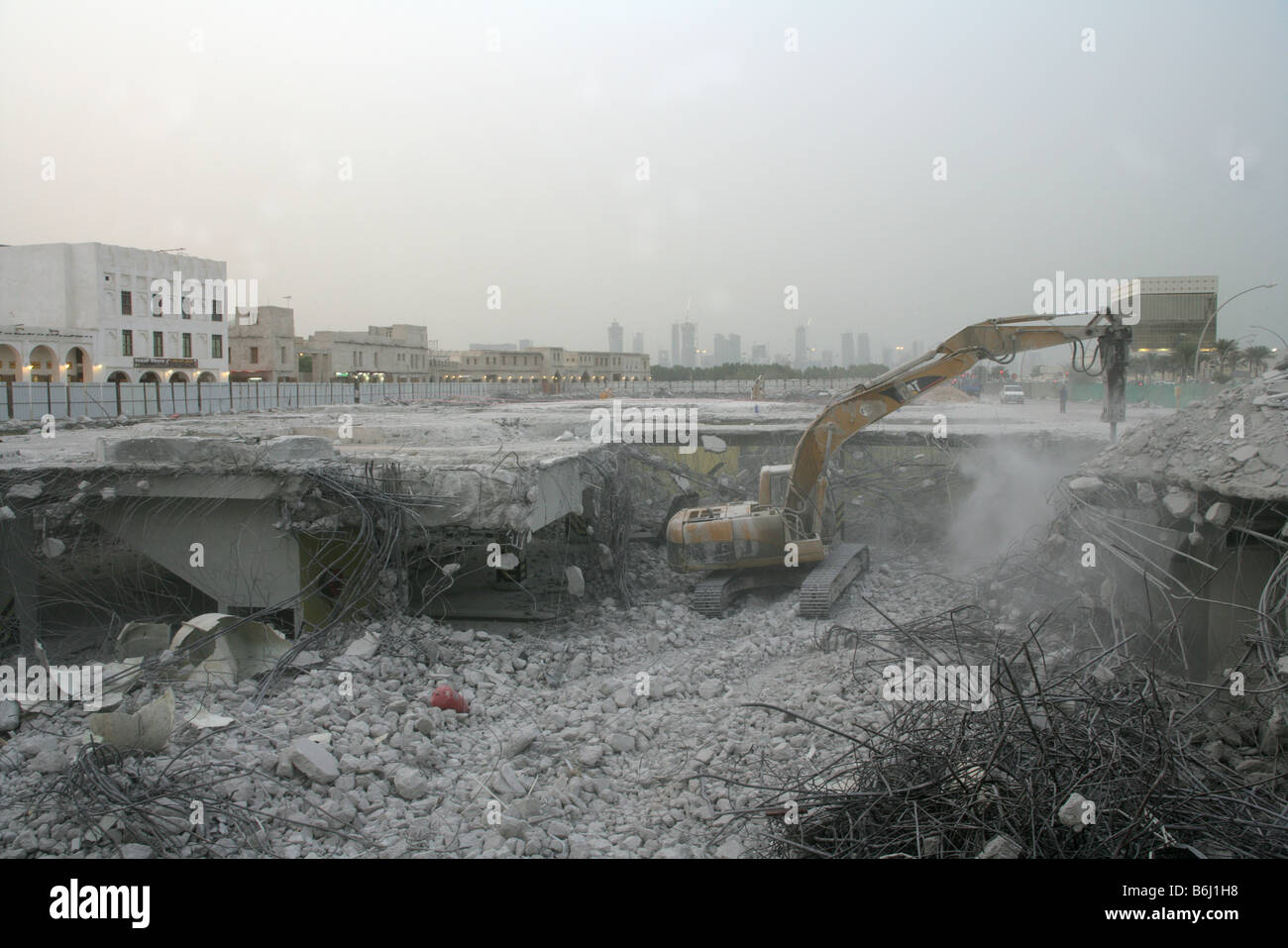 Excavator excavating rubble from city demolition site, Doha, Qatar ...
