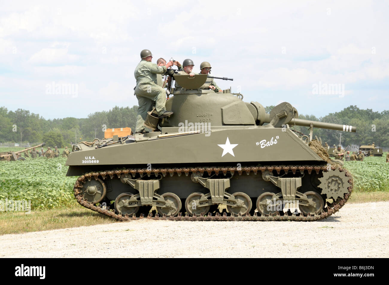A soldier on top a tank in a field during a World War II reenactment in ...