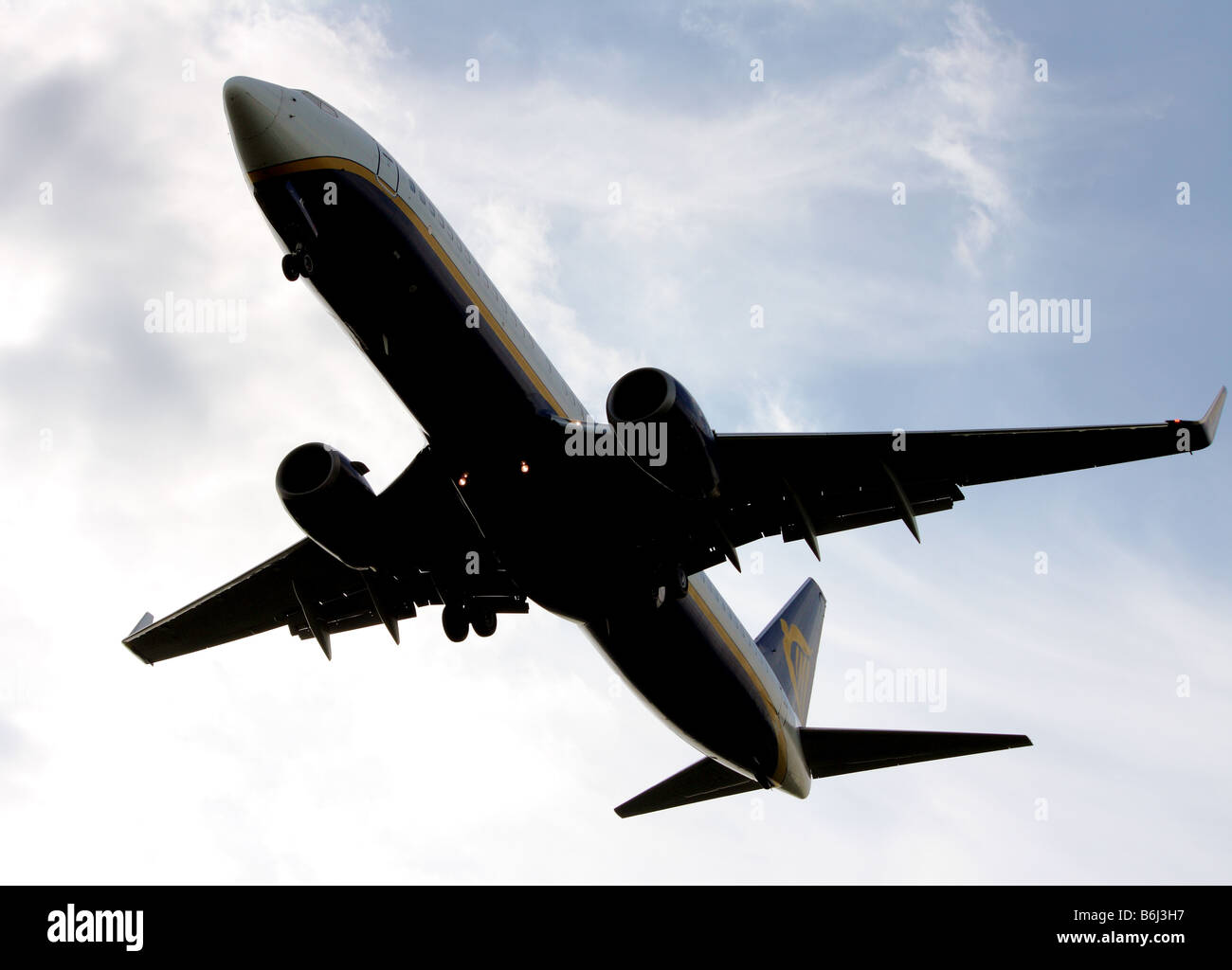 A close up of a ryanair passenger airplane flying overhead and coming ...