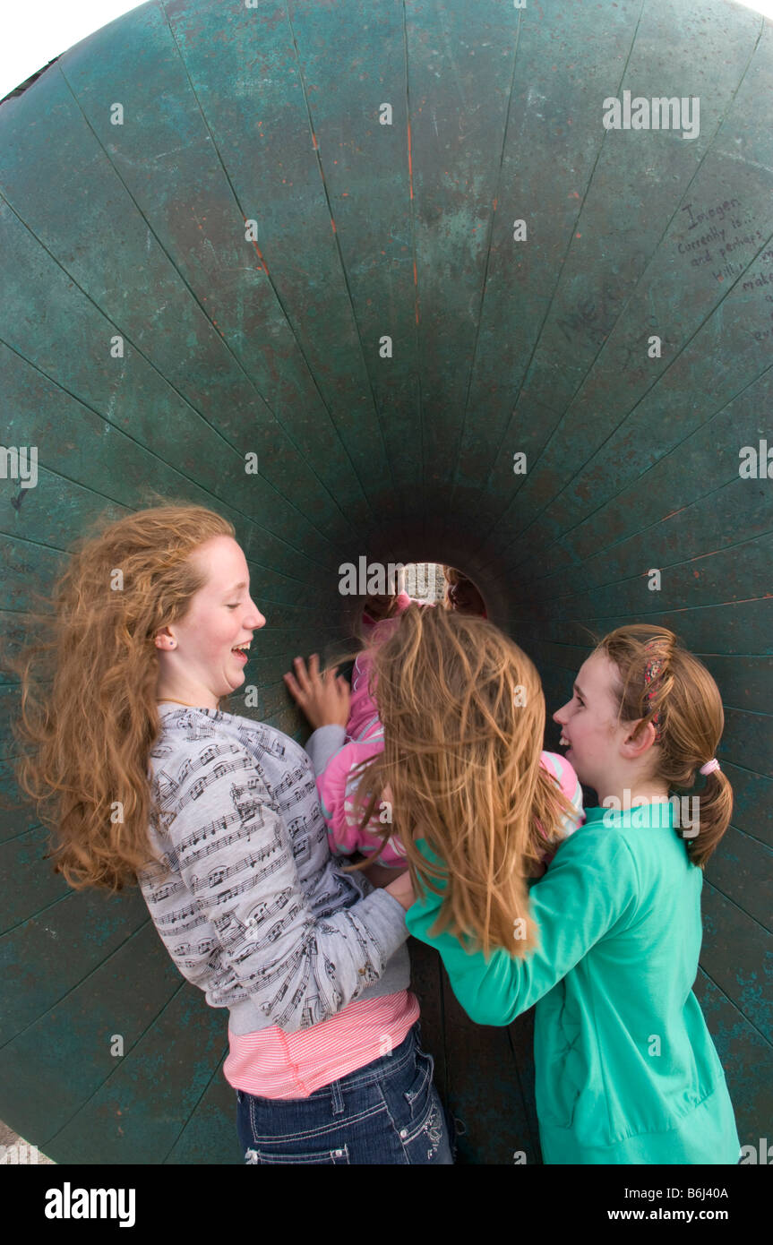 children feeding into donut Stock Photo - Alamy