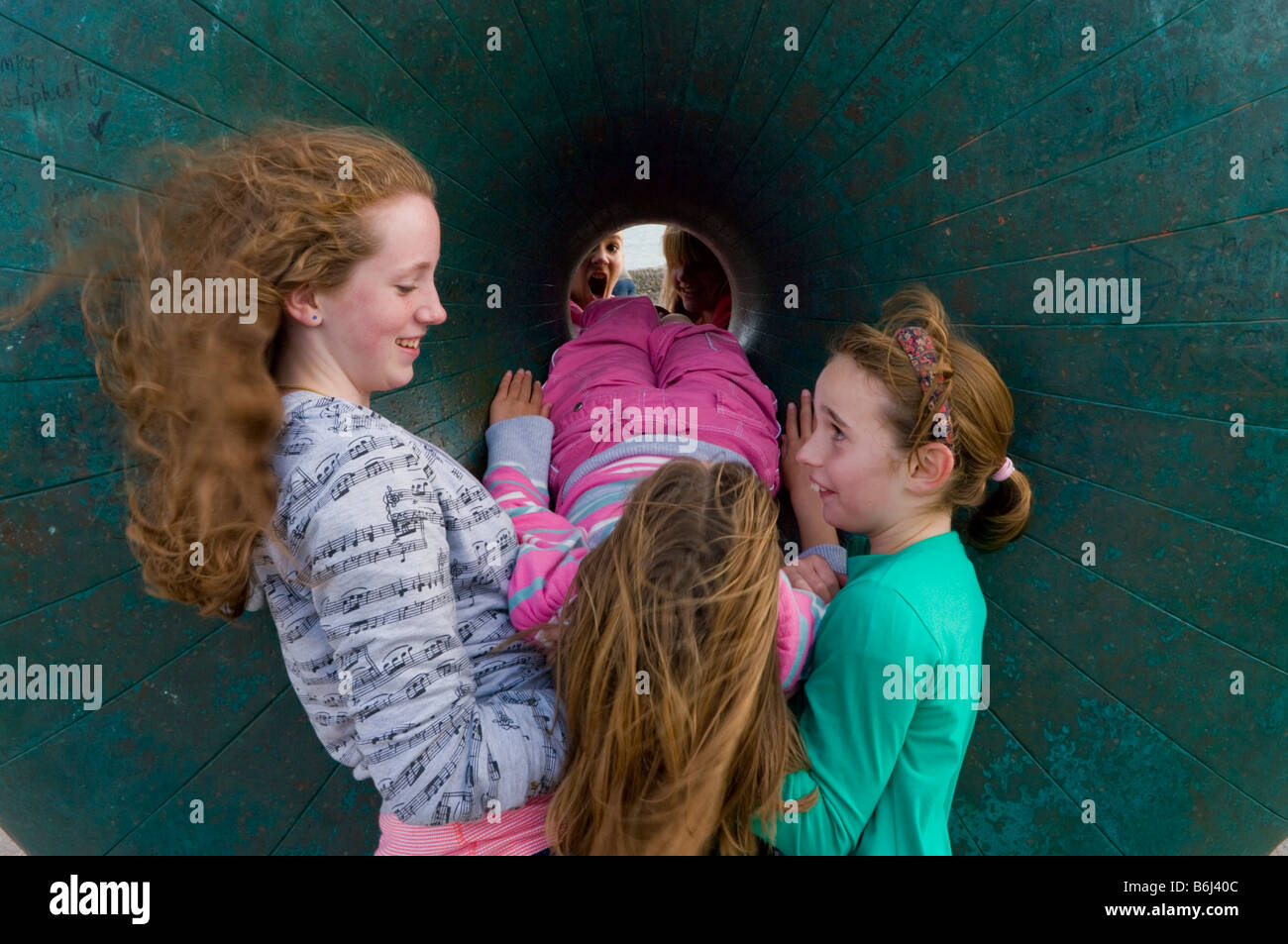 children feeding into donut Stock Photo - Alamy