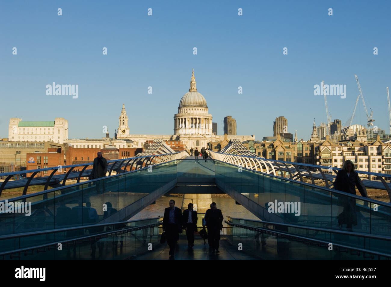 the dome of st pauls cathedral across the millennium footbridge in ...