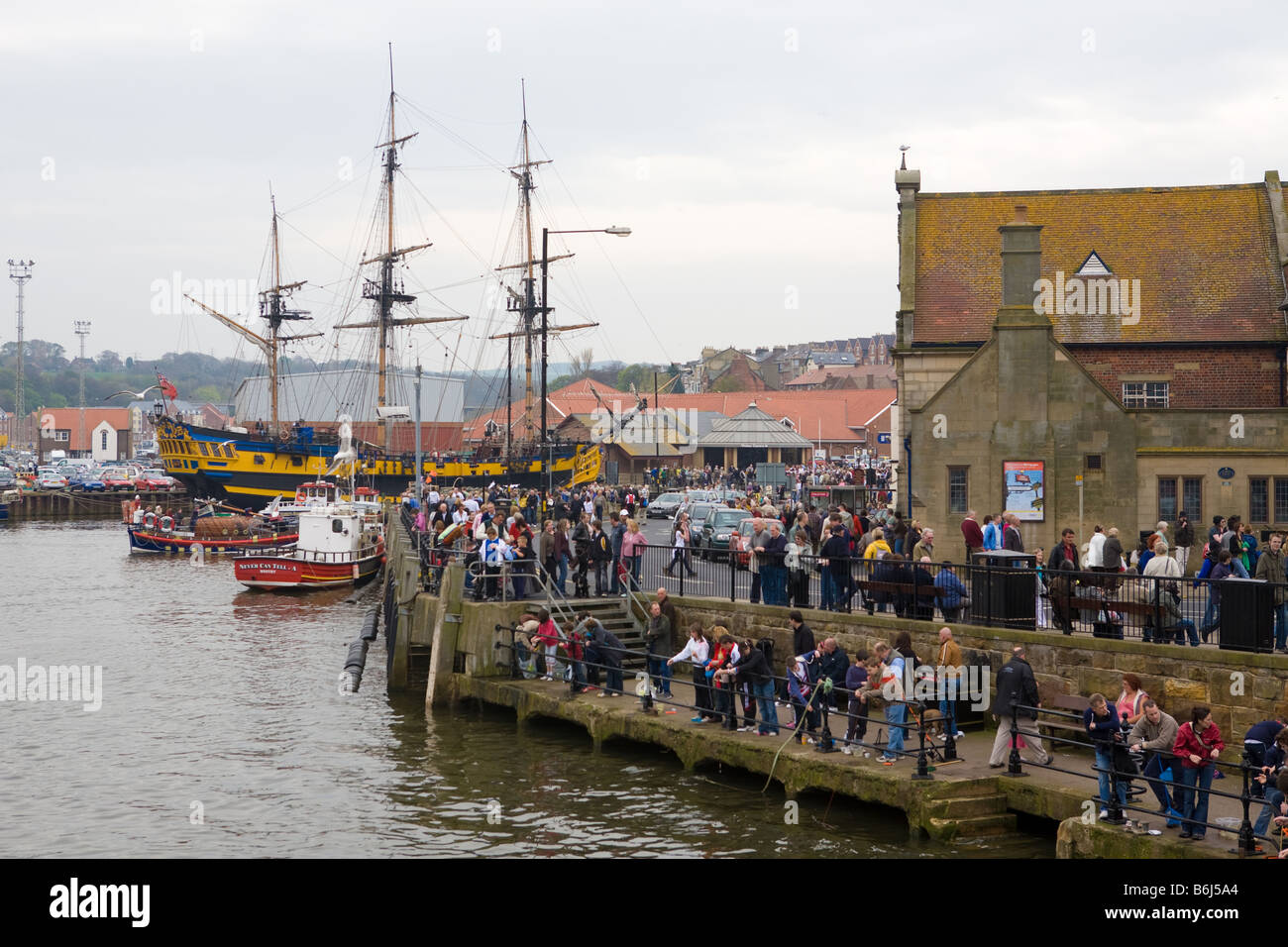Crowds on Whitby Quayside HMS Endeavour Whitby Yorkshire England Stock ...