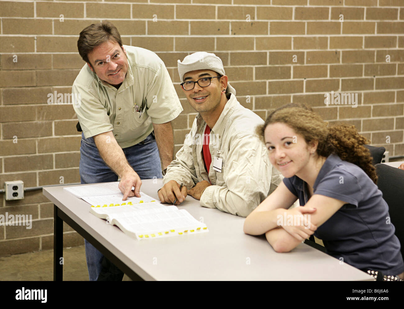 A high school or university instructor posing with students Focus on ...