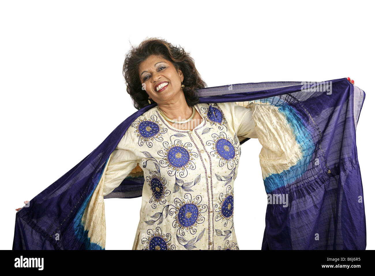 A beautiful Indian woman in traditional clothing making a welcoming ...