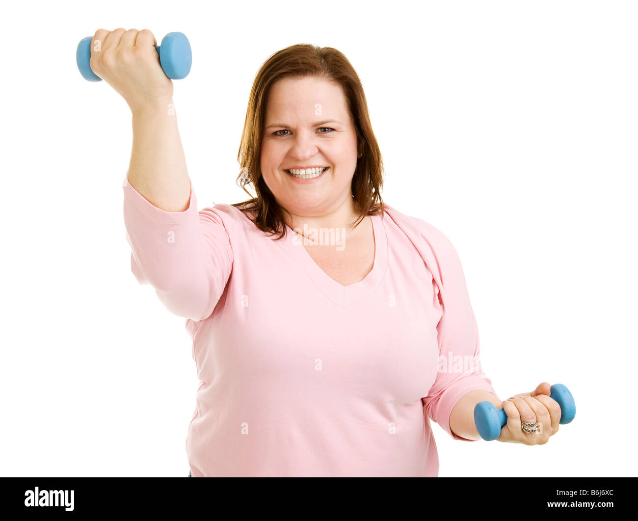 Beautiful plus sized model working out with free weights against a ...
