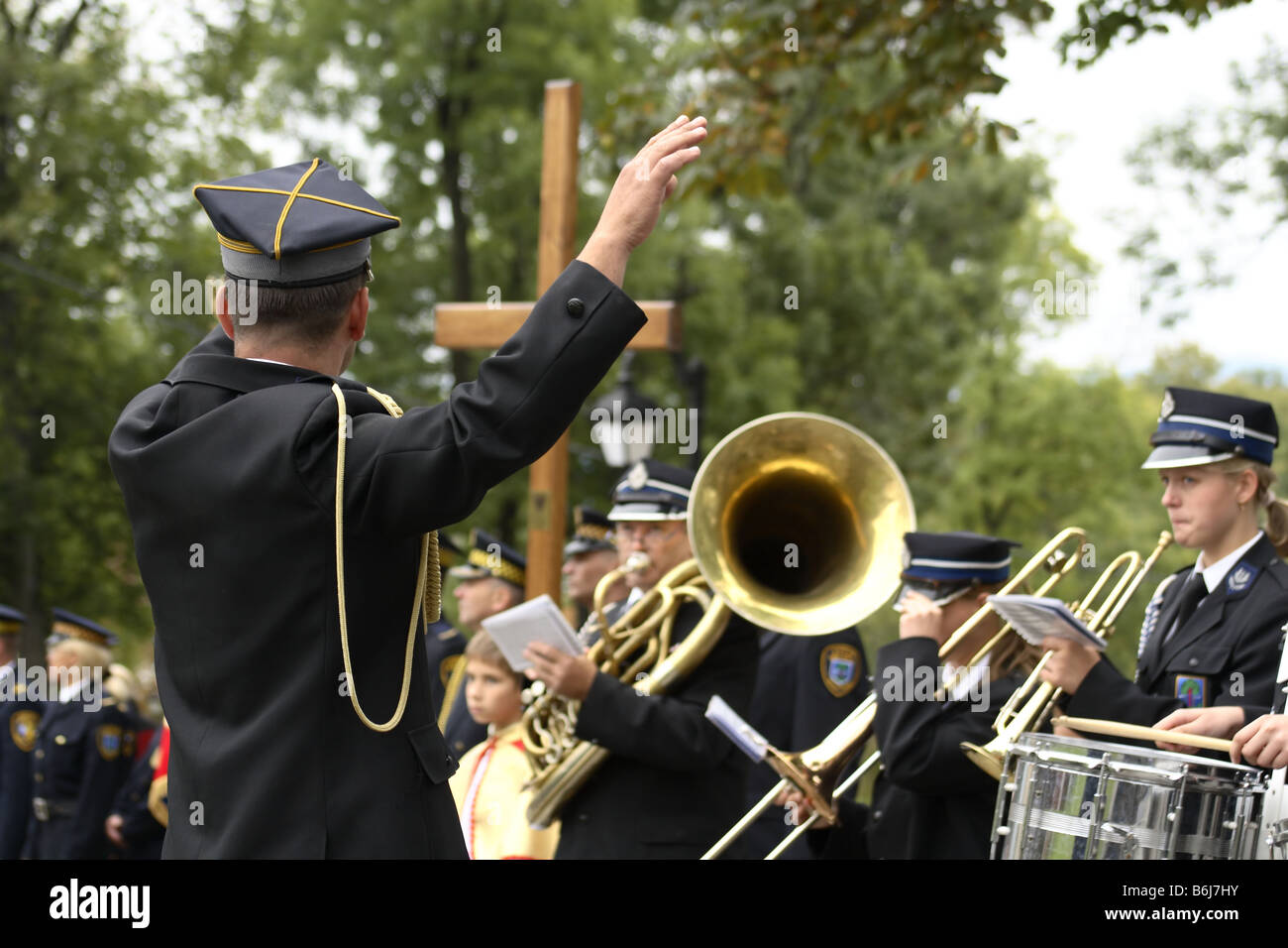 The conductor runs a brass band during a religious ceremony in Kalwaria ...