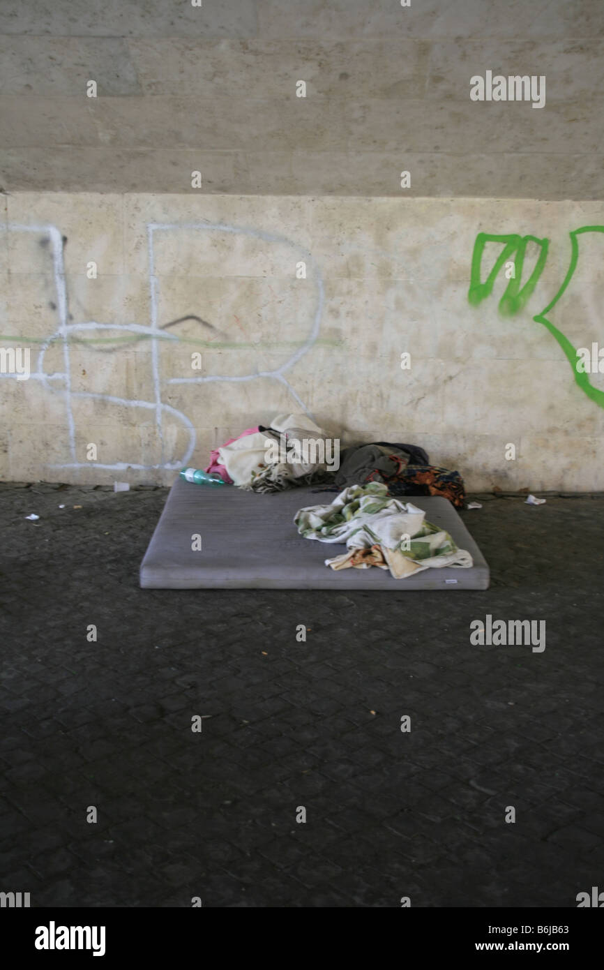 bed of homeless man person under bridge in city Stock Photo - Alamy