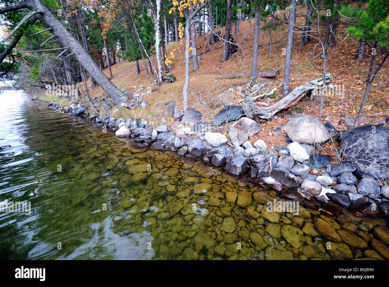 Rocky shoreline of a lake Stock Photo - Alamy
