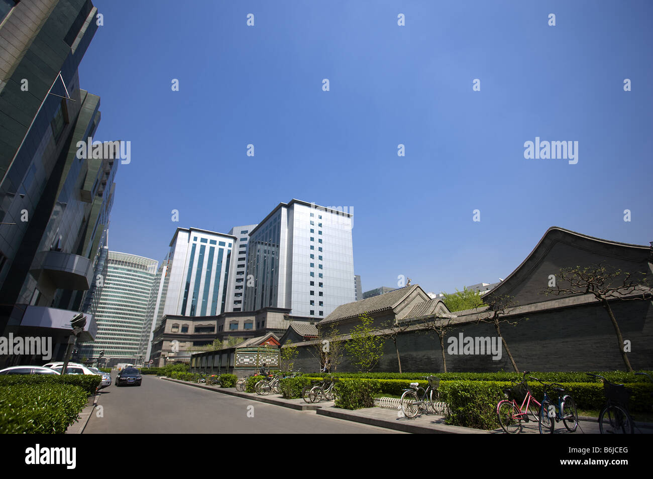 Old houses locating among the modern buildings Stock Photo - Alamy