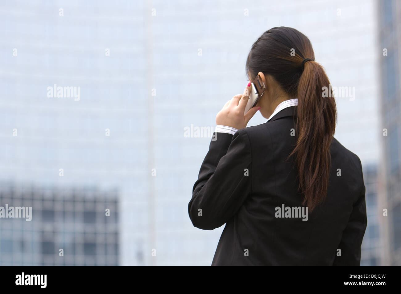 Woman on phone rear view hi-res stock photography and images - Alamy