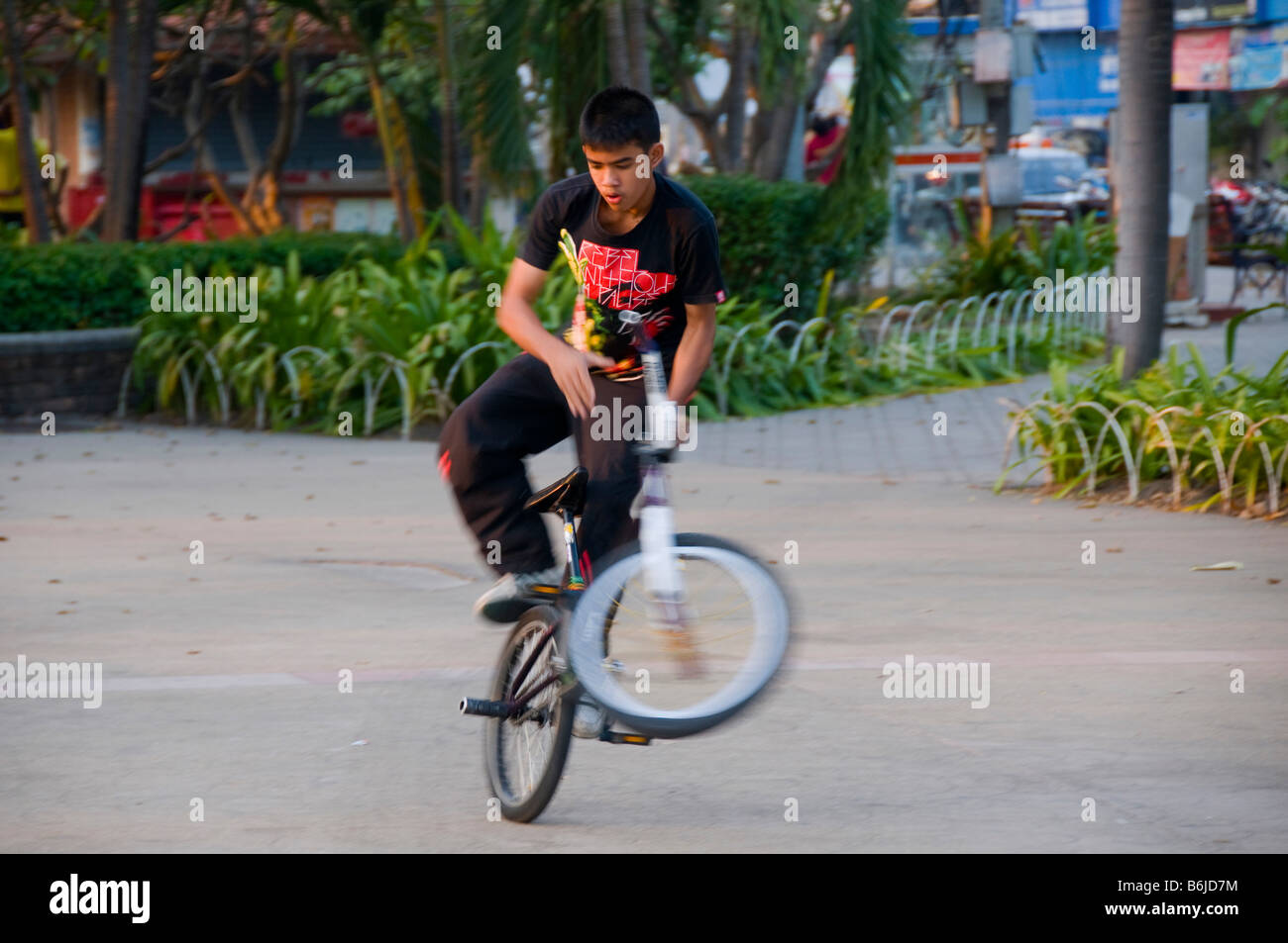 boy doing bicycle stunts in Bangkok Thailand Stock Photo - Alamy